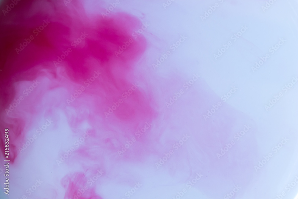 Red ink in water on a white background, vortexes and dispersion of a ...