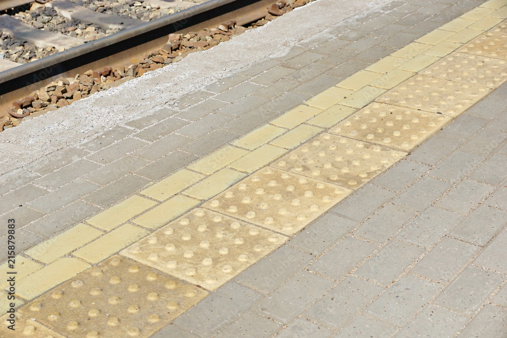 yellow tactile path for people with disabilities on the railway station ...