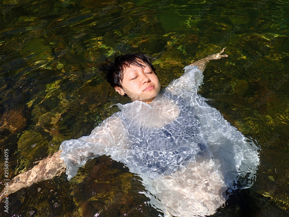 Bare upper body of the woman, lying down into the water Stock Photo ...