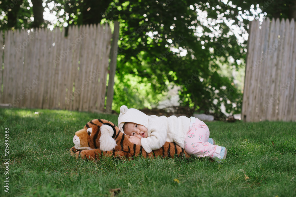 Baby resting with tiger stuffed animal Stock Photo | Adobe Stock