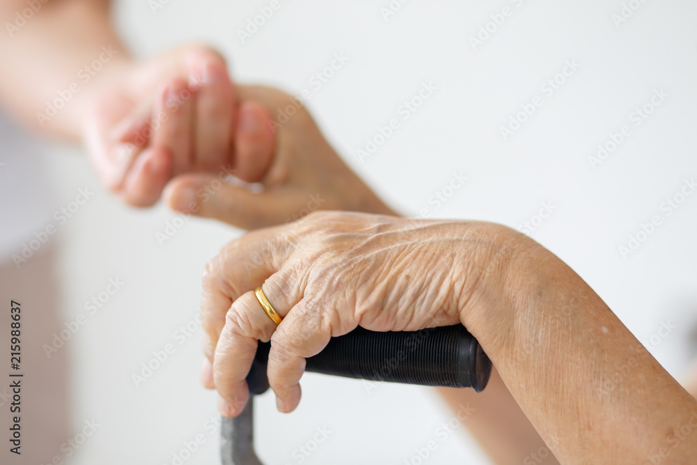 Elderly asian woman using a cane at home with caregiver take care Stock ...