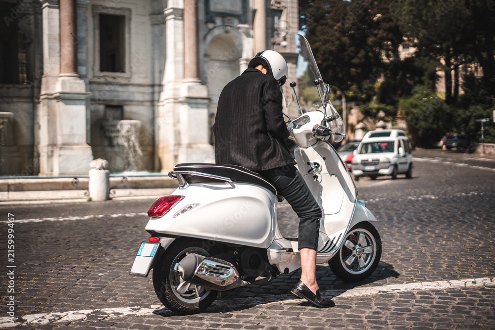 Modern and fashionable woman on a scooter / vespa in Roma Italy on a ...