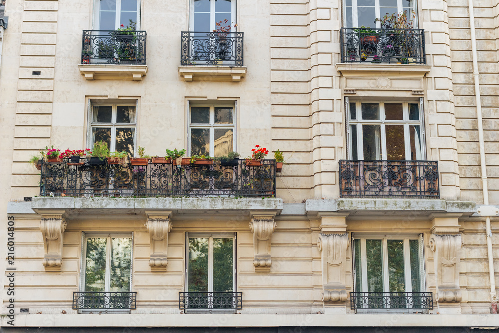 Old Paris residential buildings with balconies and flowers. Beautiful ...