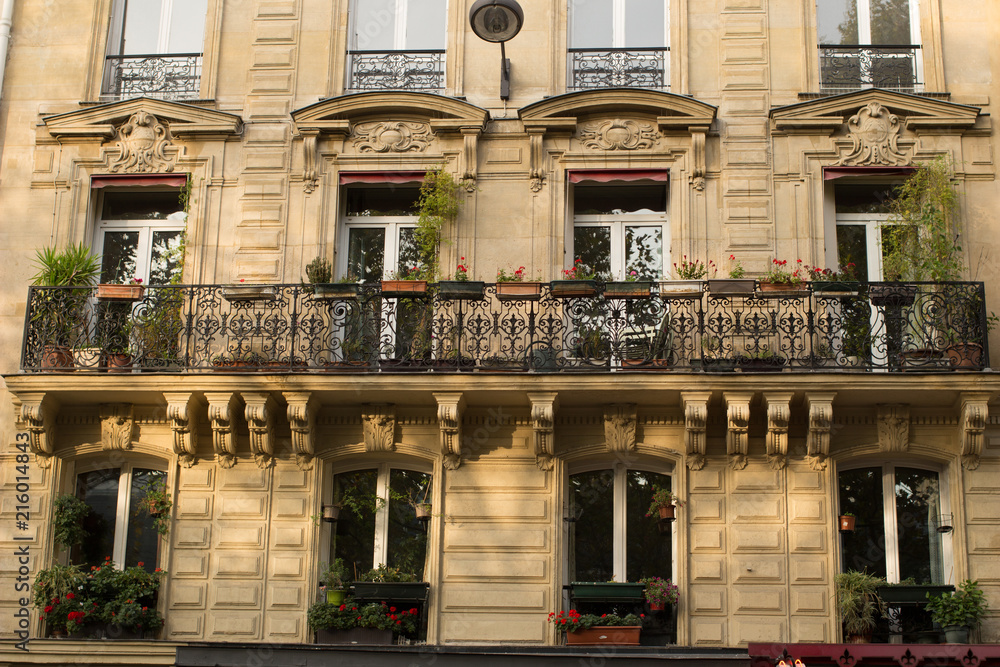 Old Paris residential buildings with balconies and flowers. Beautiful ...