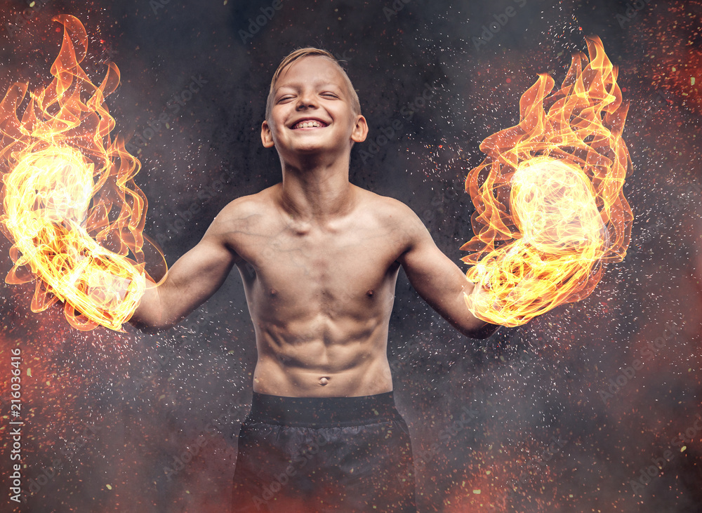 Young shirtless boy boxer wearing burning boxing gloves posing on the ...