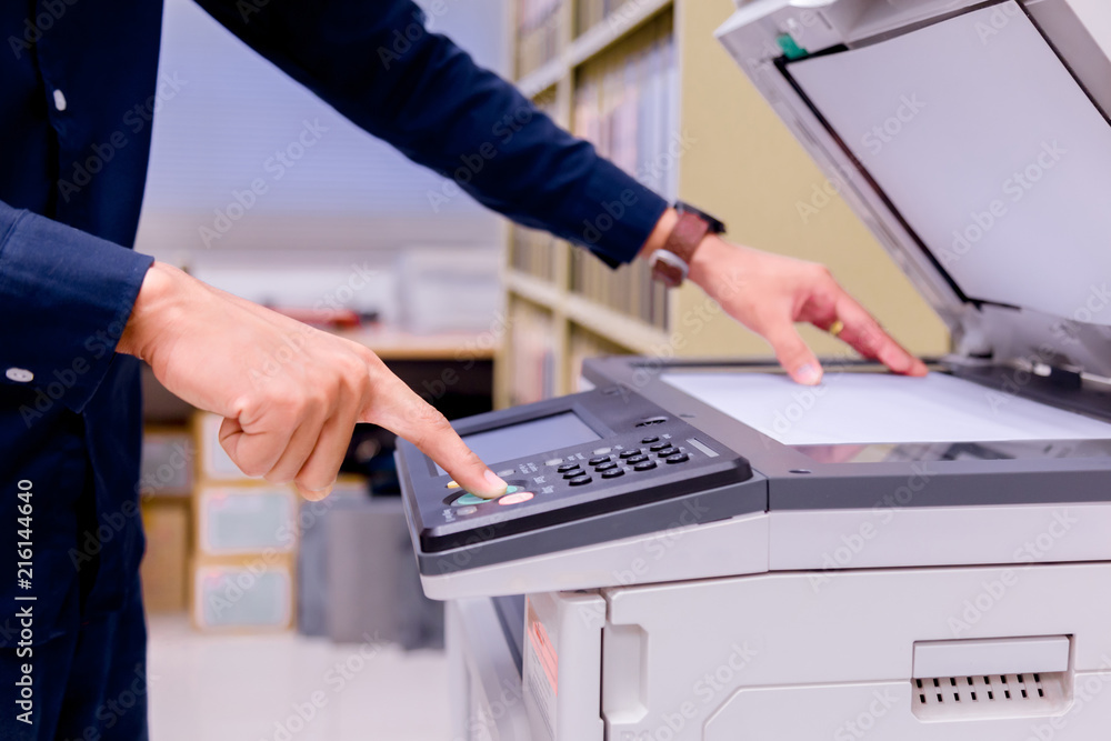 Bussiness man Hand press button on panel of printer, printer scanner ...