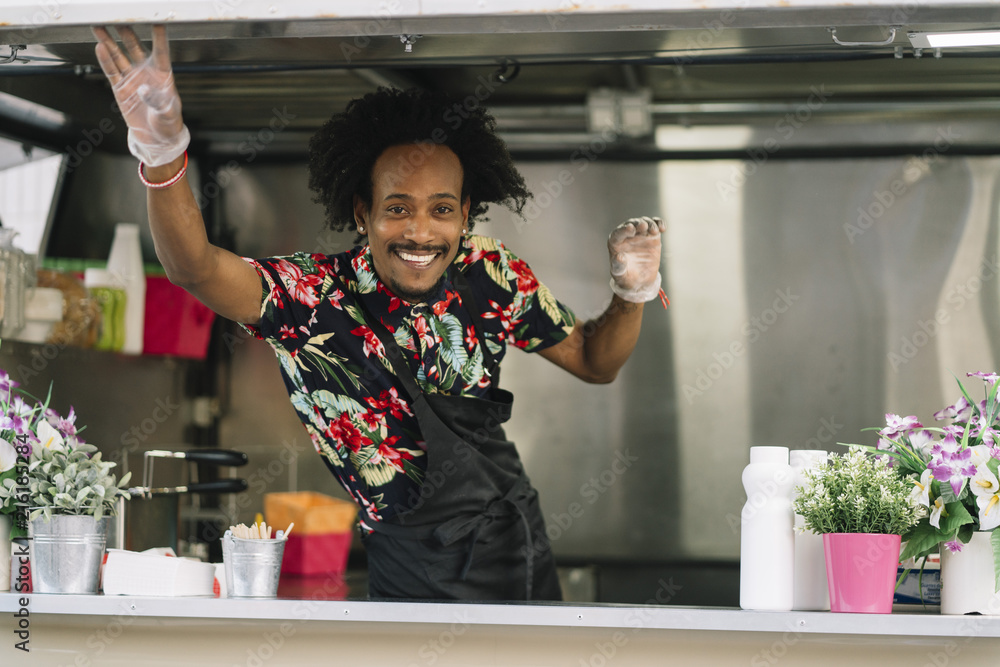 Smiling food vendor hands food to waiting customer Stock Photo | Adobe ...