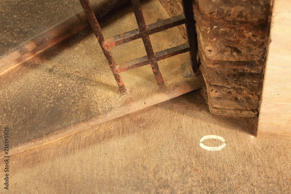 The symbol of zero at the open gate of the foot of a stone spiral ...