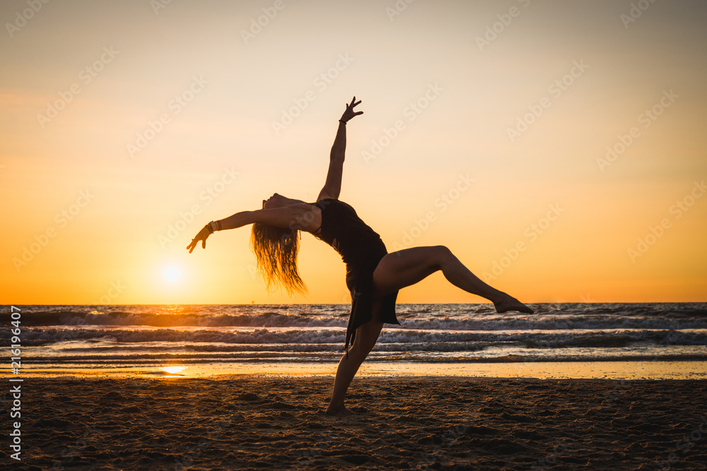 Silhouette of a happy dancer girl jumping the sunset Stock Photo ...