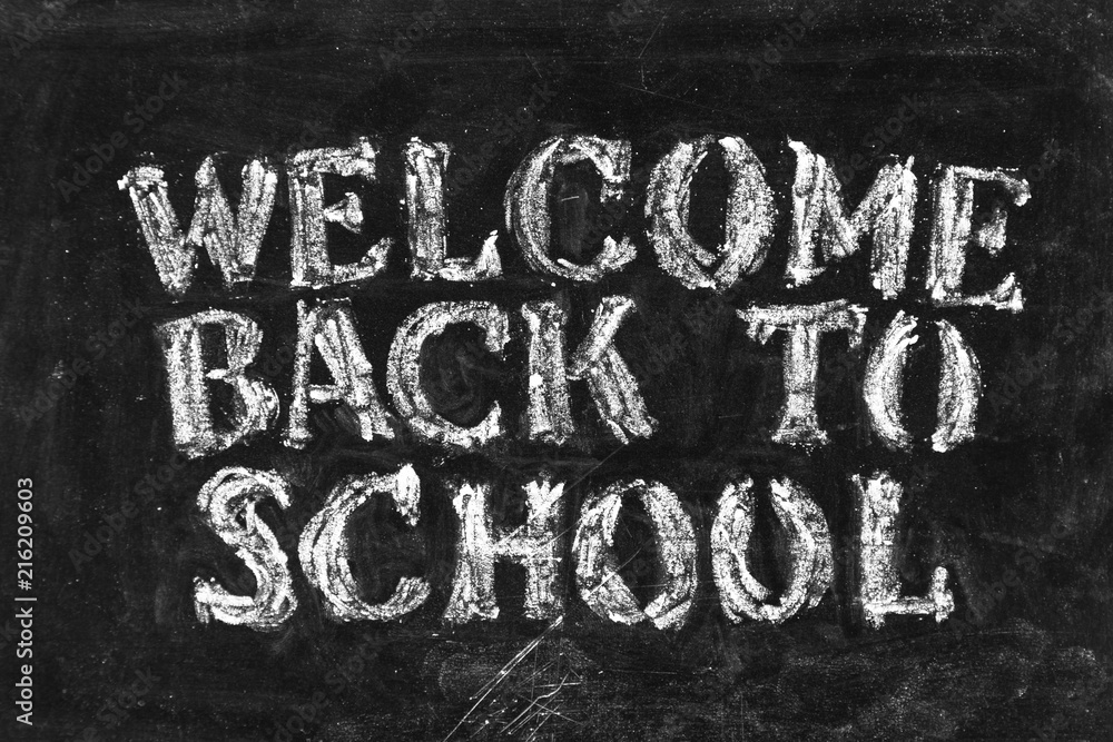 Back to school background. "WELCOME BACK TO SCHOOL" white chalk text on ...