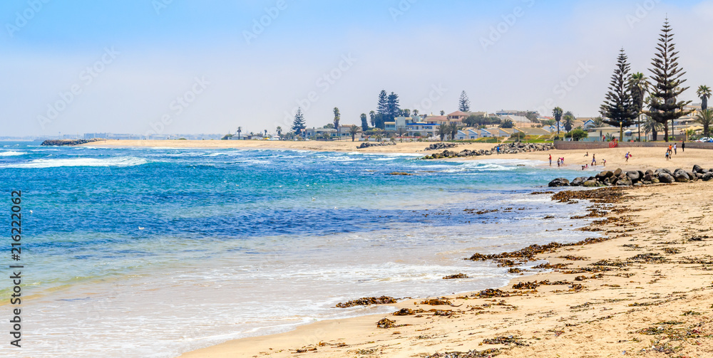 Blue ocean, sandy coastline and houses of Swakopmund German colonial ...