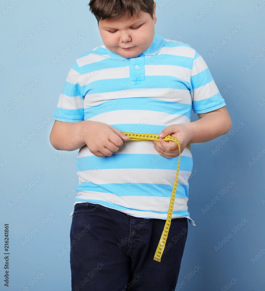 Overweight boy with measuring tape and doctor indoors Stock Photo ...