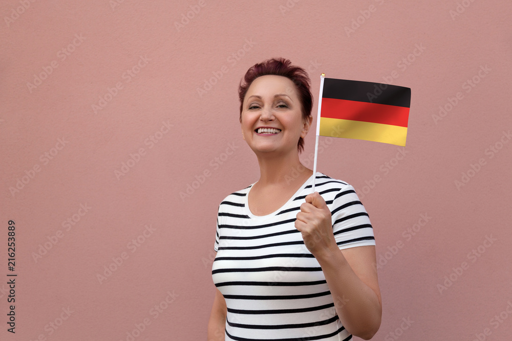 Germany flag. Woman holding German flag. Nice portrait of middle aged ...
