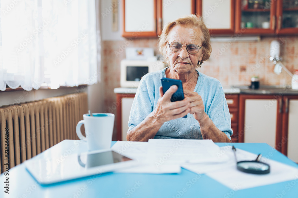 Elderly woman contacting custumer services after recieving a bill Stock ...