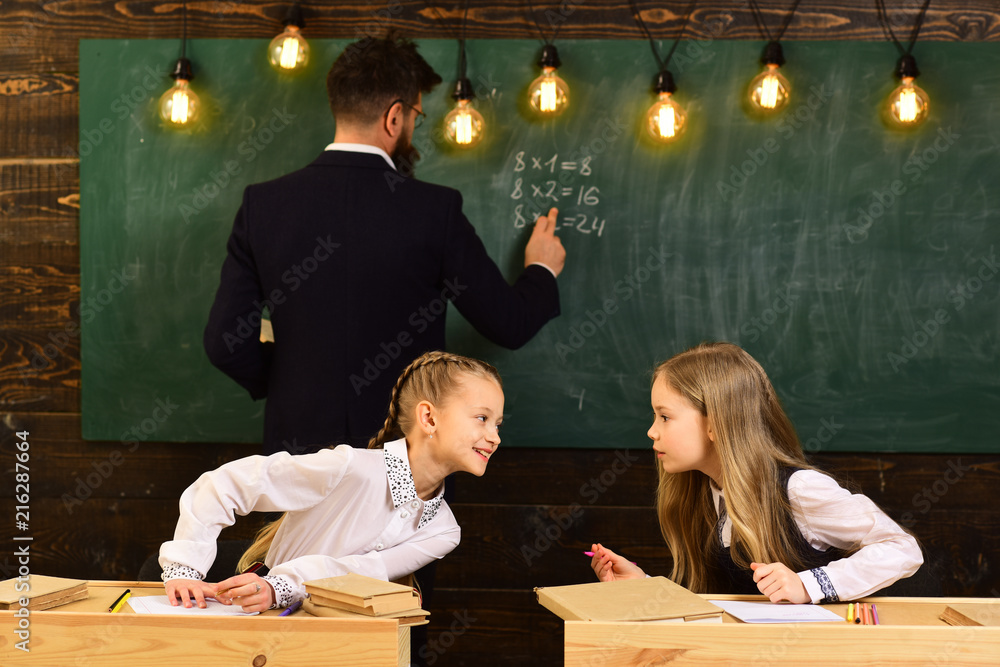 school lesson. little girls and serious teacher at school lesson ...