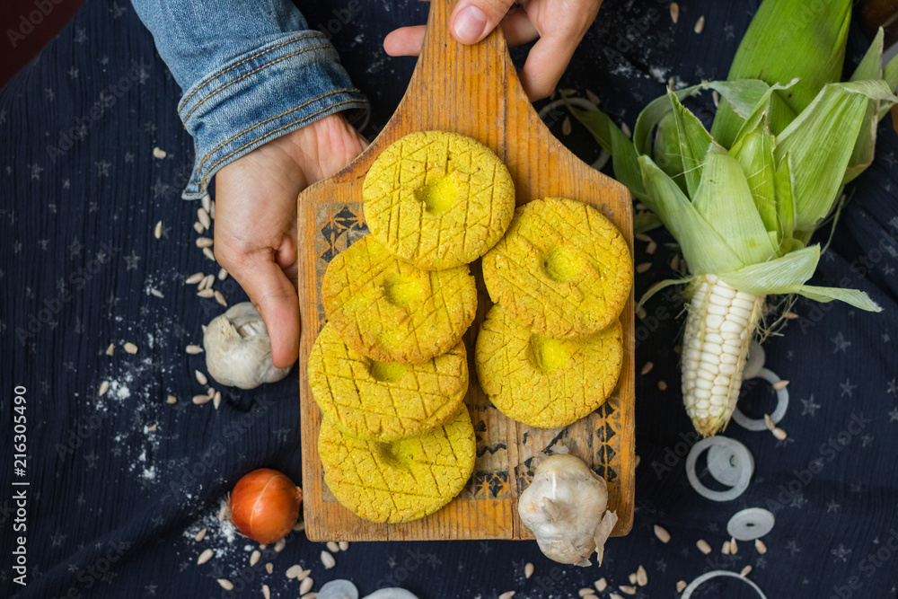 Woman hands holds Mchadi - traditional Georgian cornbread traditionally ...