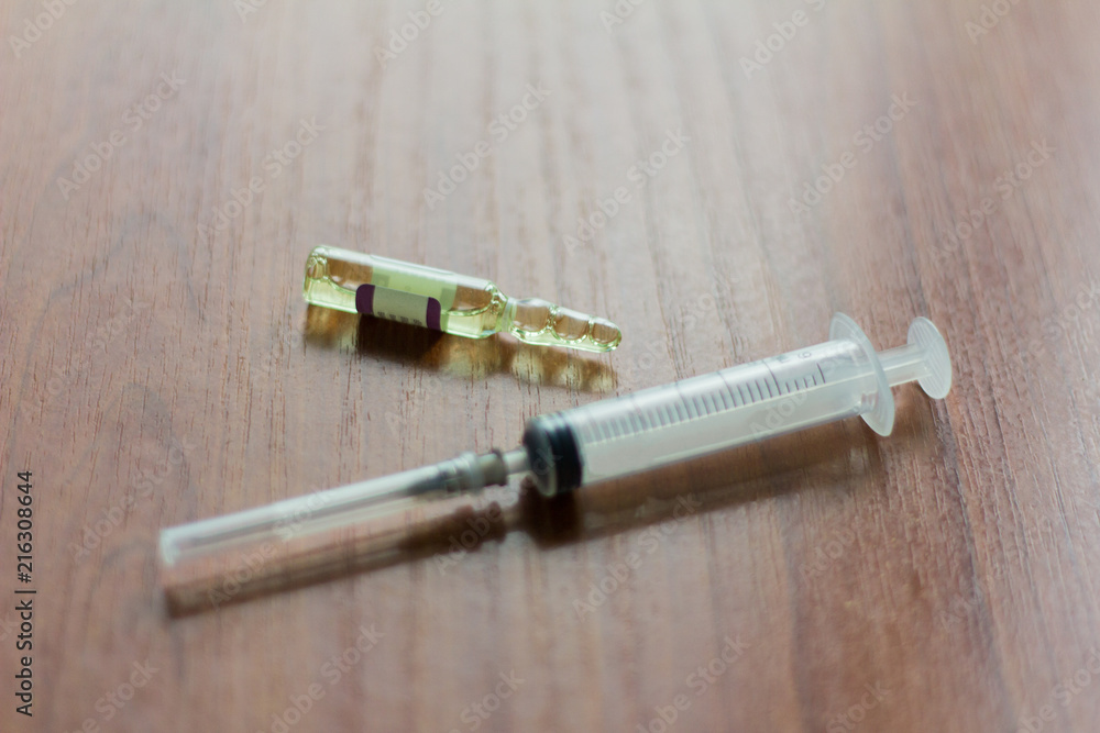 the vial of medication and a syringe for injections on the table Stock ...