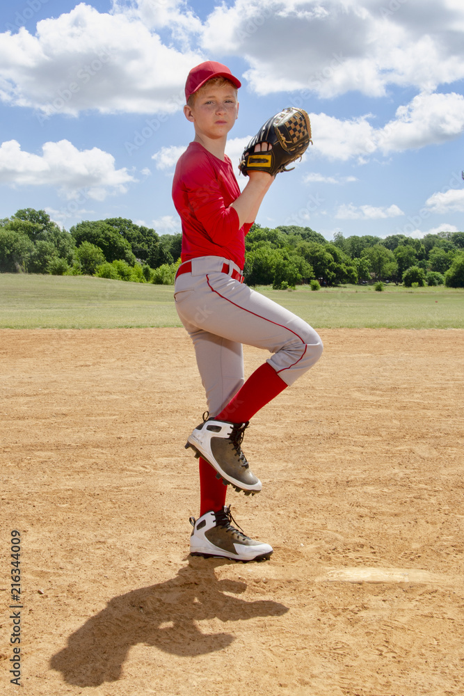 Male youth baseball player winding up to pitch Stock Photo | Adobe Stock