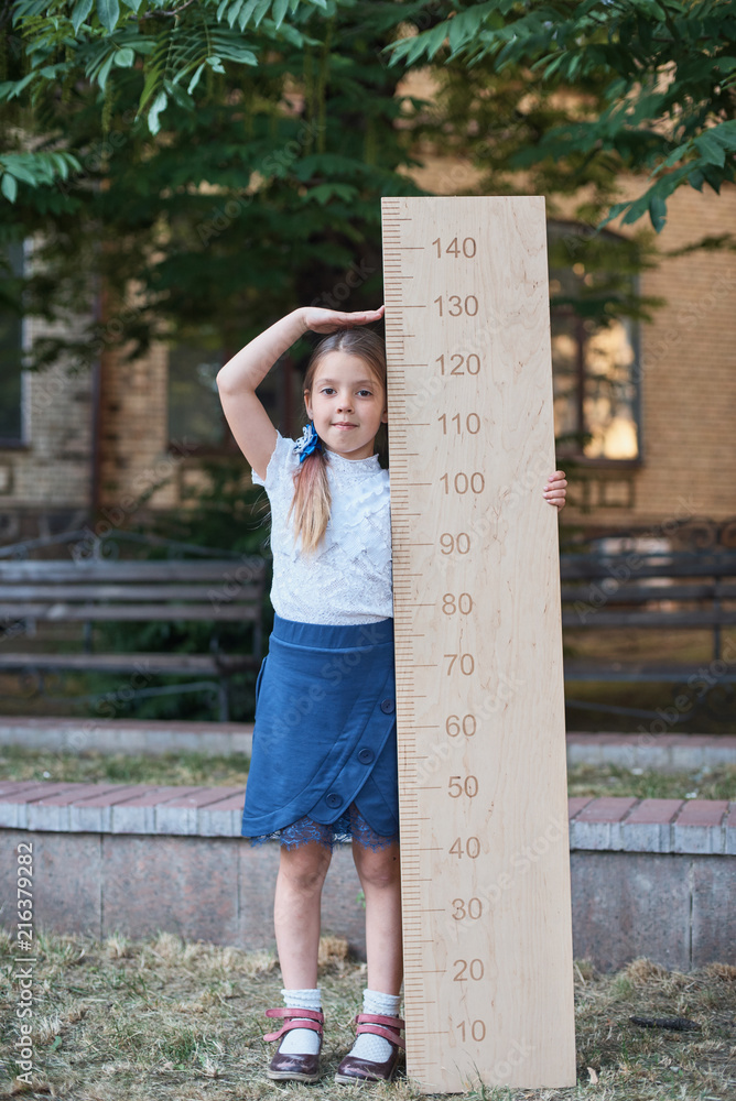 girl with big ruler standing on park background. Farewell Bell. day of ...