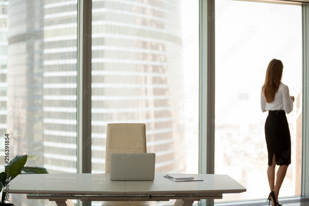 Foto de Successful boss businesswoman standing looking out office ...