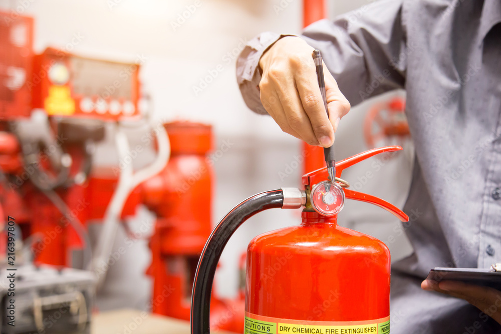 Engineer inspection Fire extinguisher in control room. Stock Photo ...