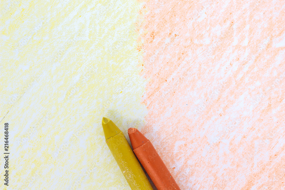 yellow and orange crayon drawings on white paper background texture ...