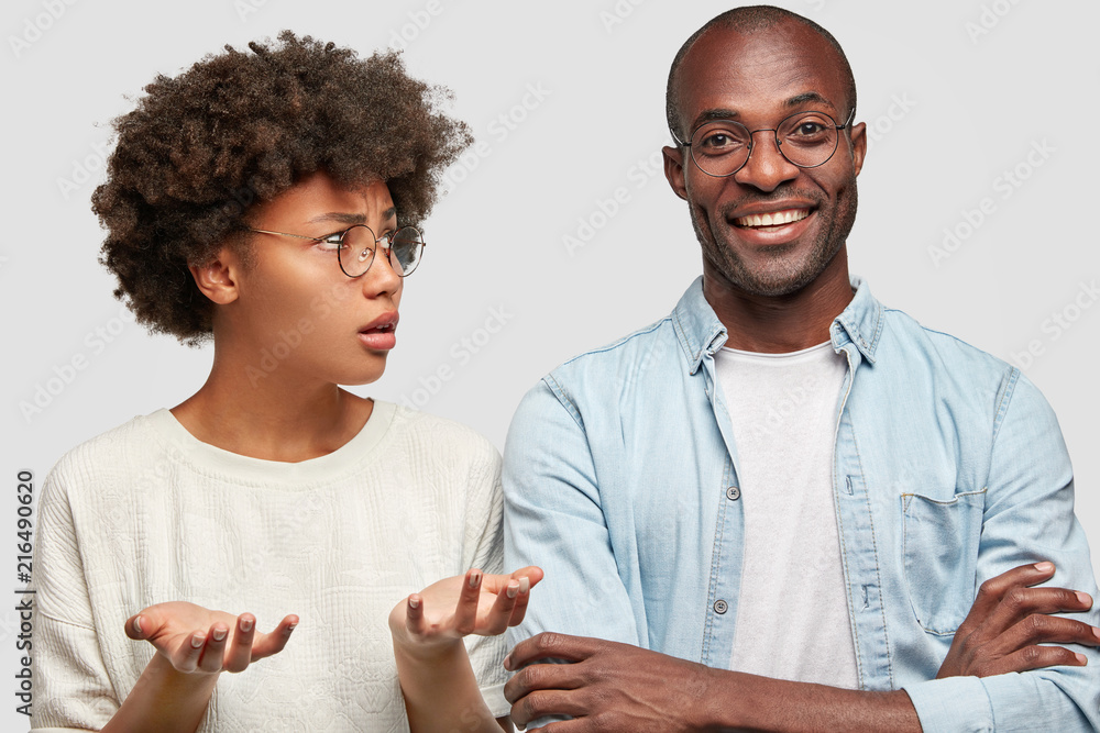 Why are you laughing? Displeased African American female looks at her ...