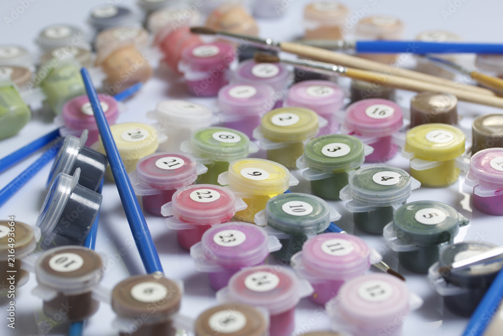 Numbered containers with paints and brushes of different sizes. For ...