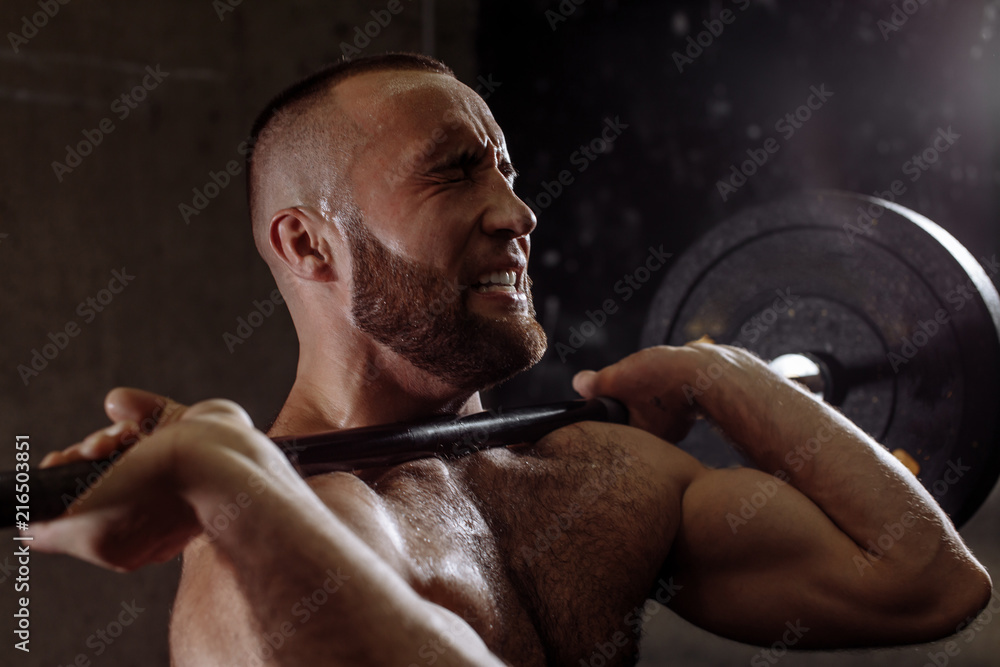 frustrated emotional sporty man lifting the weight. side view shot ...