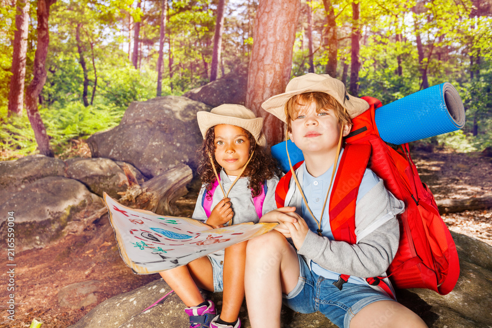 Two kids in forest navigate with map treasure hunt Stock Photo | Adobe ...