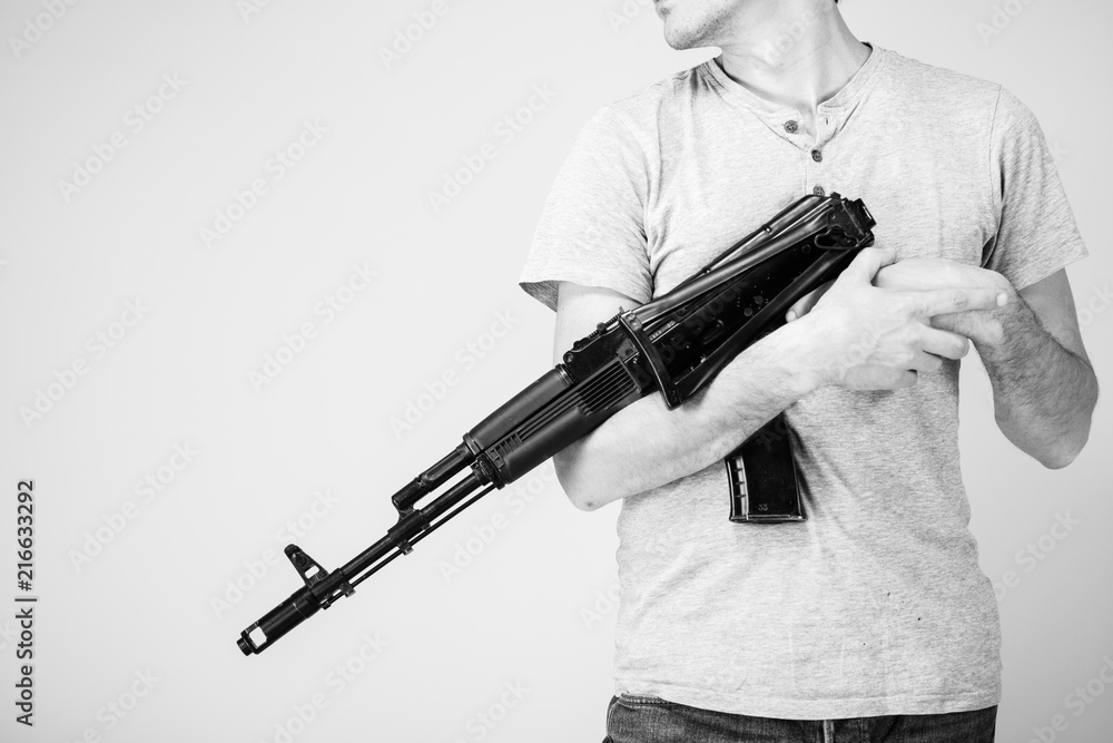 Man in angry expression pose with machine gun. Photo studio shooting ...