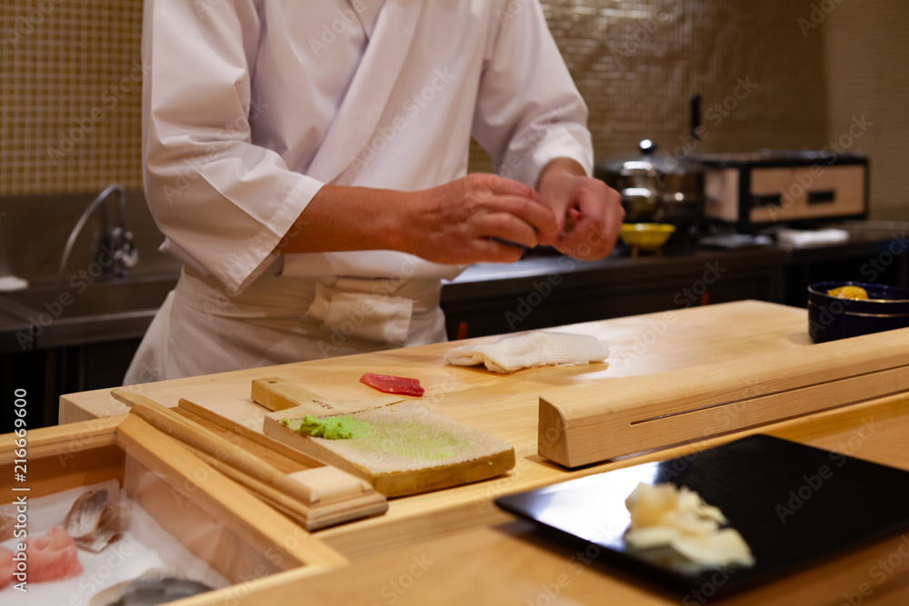 Professional sushi chef carefully using just the right pressure to make ...