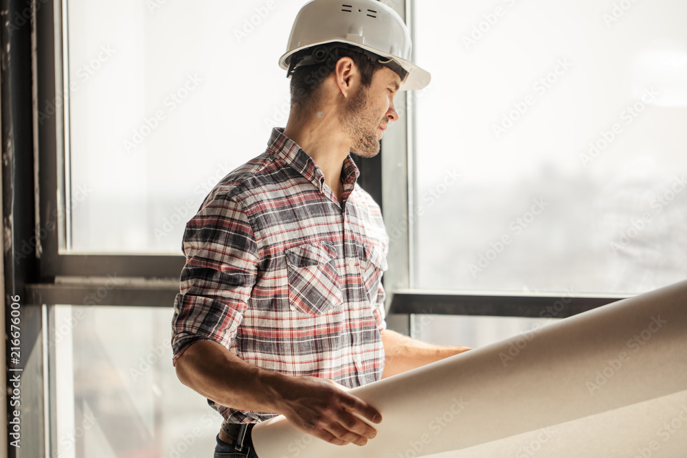 awesome man is sketching the construction project. engineering concept ...