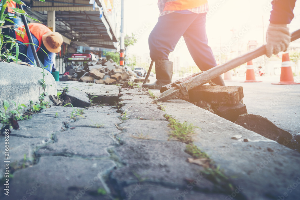 labors are constructing pedestrian walkways; workers building and ...