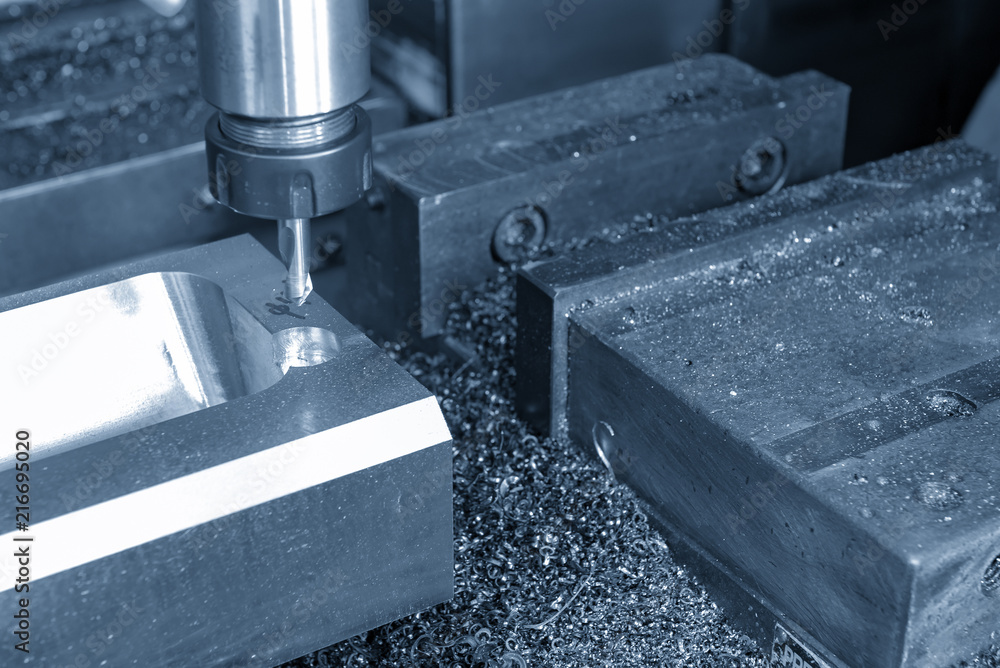 The CNC milling machine drilling the hole at tire mold part with the ...