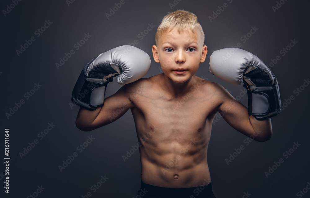 Young shirtless boy boxer with boxing gloves posing in a studio. Stock ...