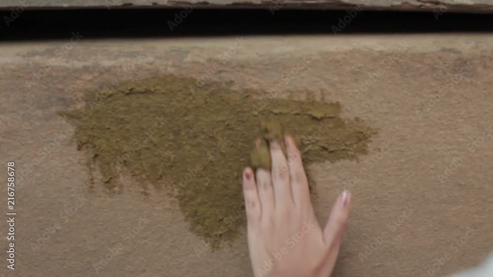 Sade village traditional daily activity, moping with fresh cow dung. A ...