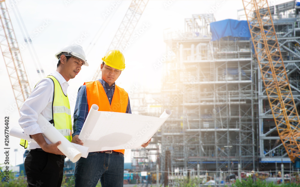 two construction engineer working in construction site and management ...