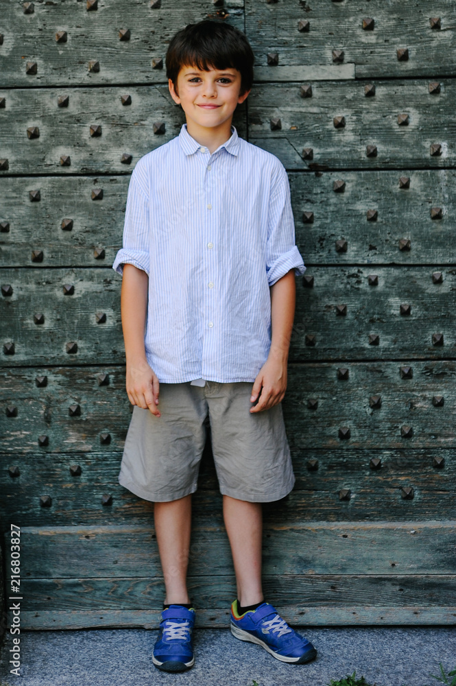 10 year old child posing in front of an old green door Stock Photo ...