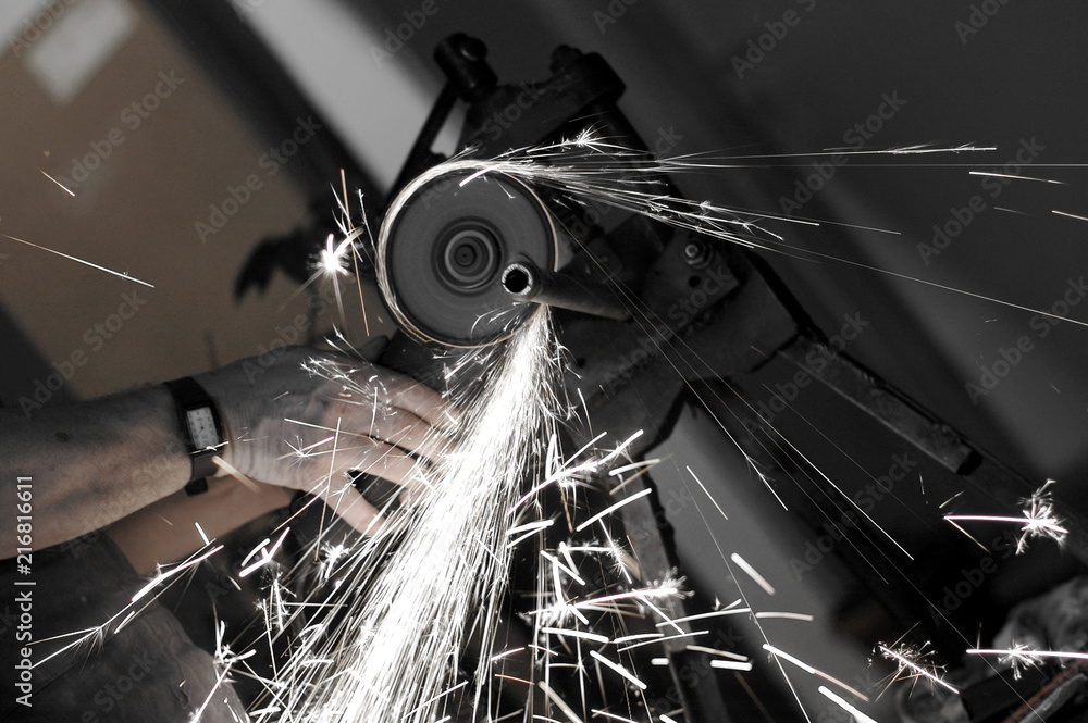 Angle grinder in use, cutting pipes for waterwork. Stock Photo | Adobe ...