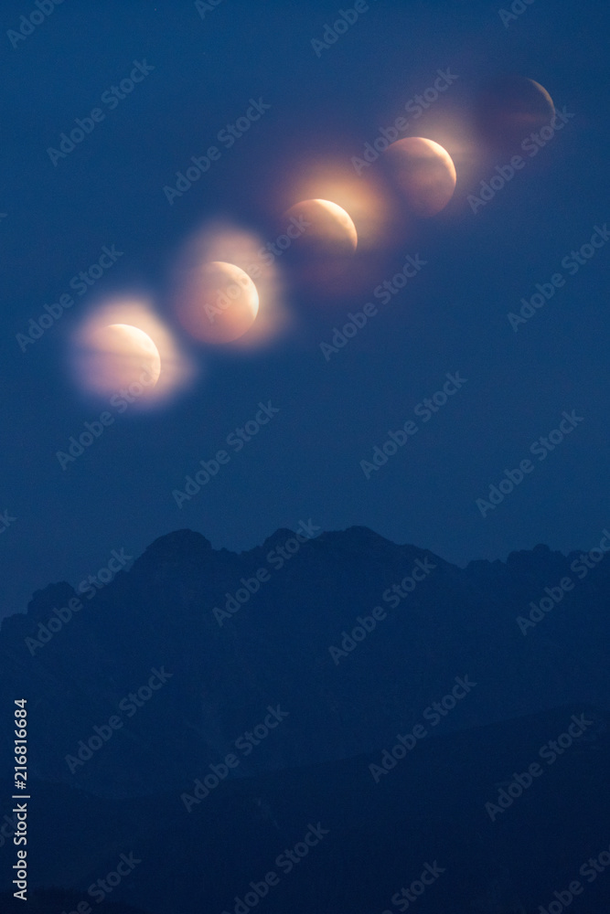Lunar eclipse over the High Tatra mountains. Time series image of the ...