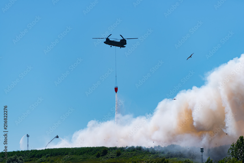 chinook helicopter extinguishes a large fire Stock Photo | Adobe Stock