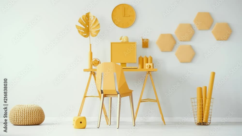 Bright yellow home office interior with desk, computer, chair, pouf and ...