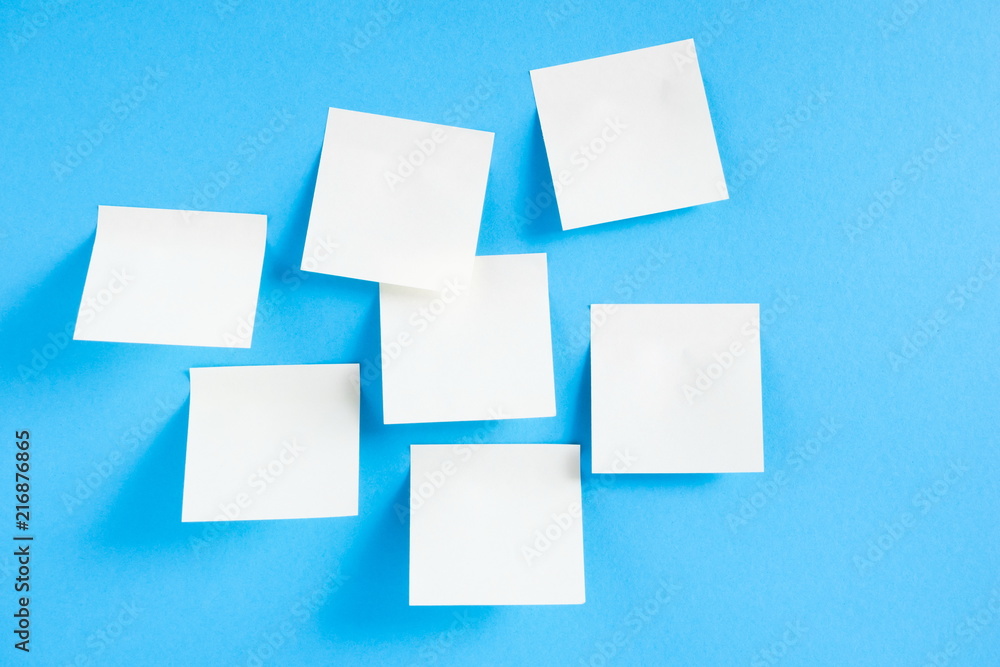Blank white sticky notes on blue background, concept of business work ...