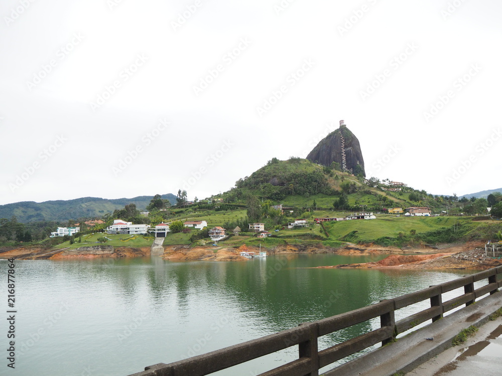 The Rock of Guatape on a cloudy and rainy day, La Piedra or El Peñol ...