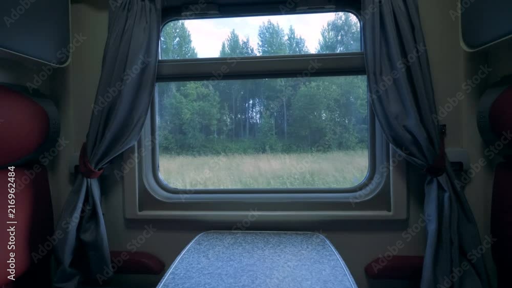 Forest landscape shown through the window of a train coach. Railroad ...