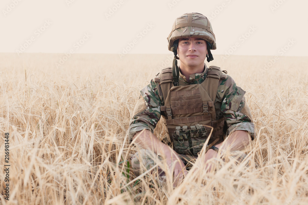 Soldier man standing against a field. Portrait of happy military ...