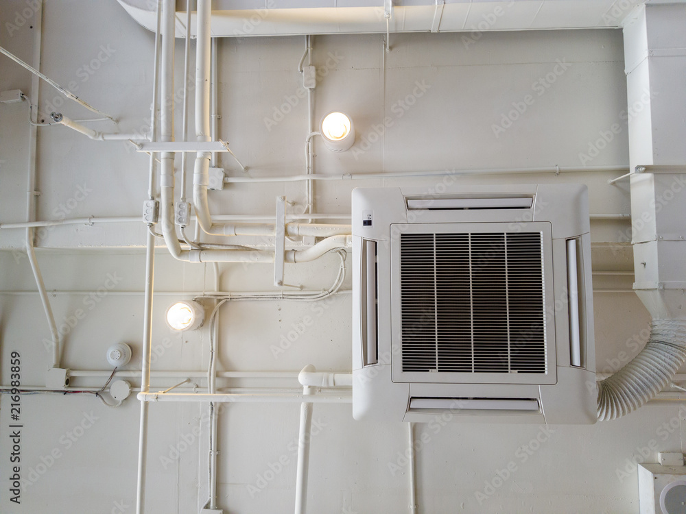 White Industrial air conditioner cooling pipe with plumbing at ceiling ...