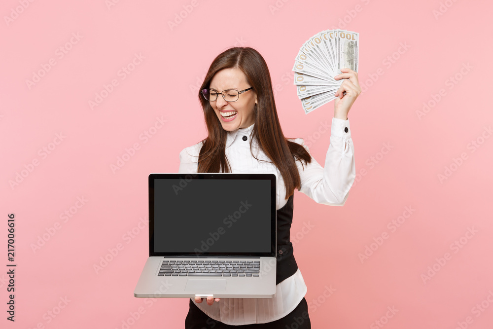 Young laughing business woman holding bundle lots of dollars, cash ...