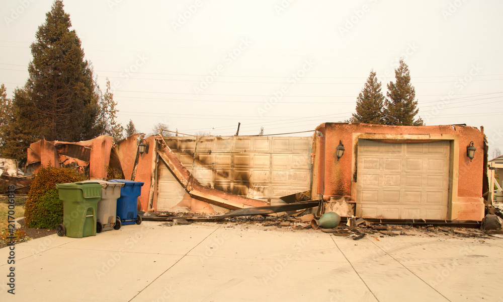 home severely burned with walls leaning and stucco hanging in the ...